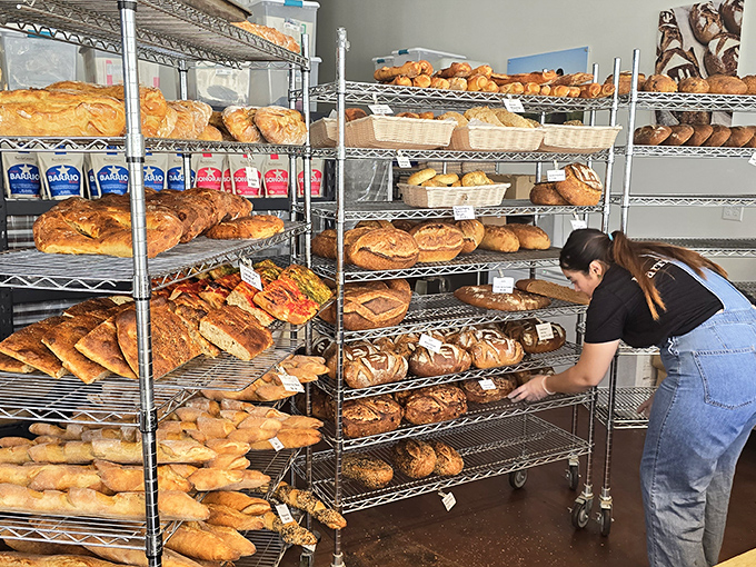 Racks of freshly baked treasures await their forever homes, each loaf a testament to patience, skill, and the magic of fermentation.