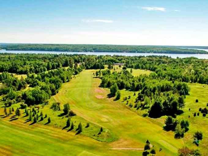 Lush fairways stretch toward the horizon at this golf course, where the game is enhanced by breathtaking views of Michigan's Upper Peninsula landscape.