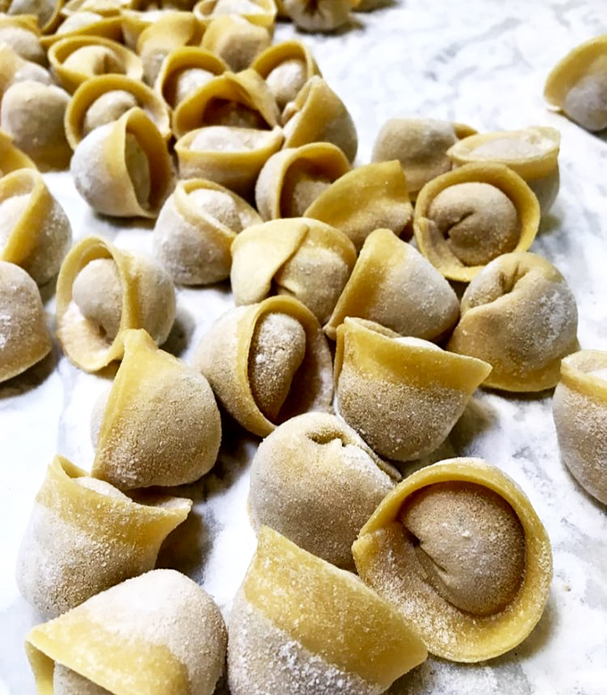 Each handmade tortellini represents a tiny edible treasure chest, dusted with flour and filled with promises of flavor that exceed expectations.