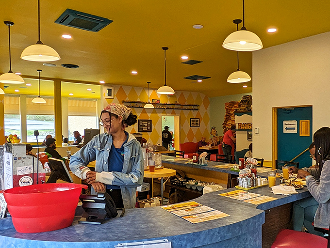 The open kitchen and counter setup invites conversation between cooks, servers, and hungry patrons.