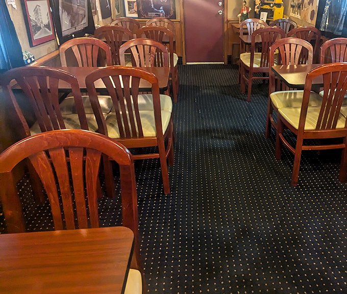 Wooden chairs arranged throughout the dining car create an atmosphere where strangers often become friends over shared discoveries and good food.