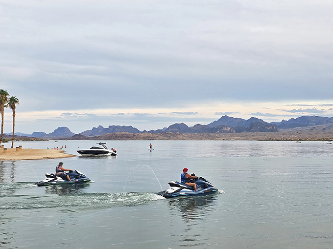 Jet skis carving through blue &ndash; creating temporary signatures on Lake Havasu's liquid canvas.