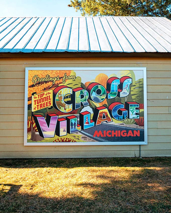 "Greetings from Cross Village" – this vintage-style mural captures the charm of the northern terminus of the Tunnel of Trees.