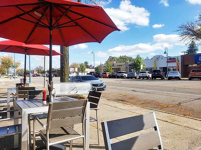 Outdoor seating under cheerful red umbrellas &ndash; where breakfast meets fresh air and people-watching becomes an unofficial side dish.