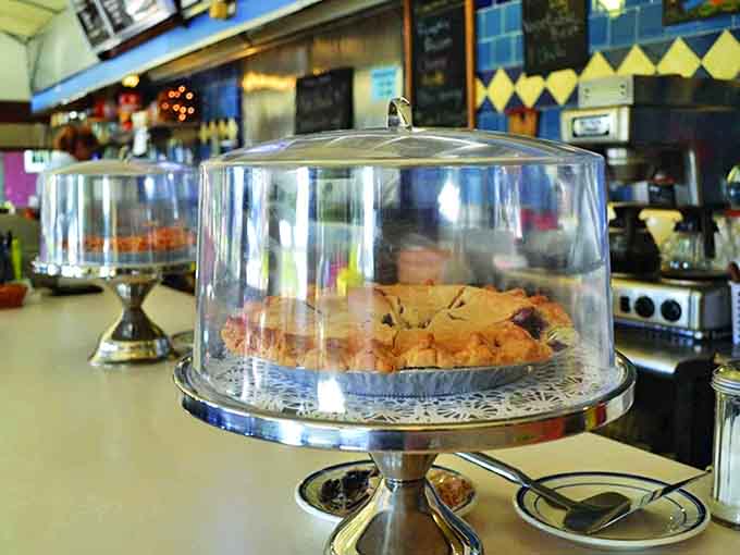 Homemade pies wait under glass domes like treasures, each slice offering the perfect sweet ending to your diner adventure.