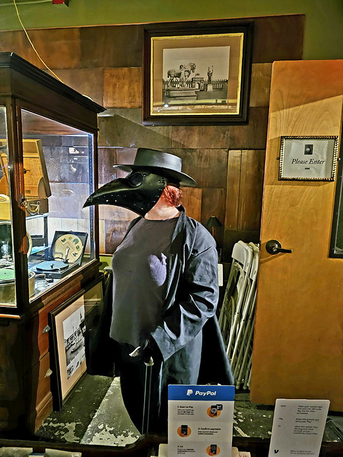 The plague doctor costume stands sentinel, its beaked mask and dark attire a chilling reminder of historical responses to epidemics past.