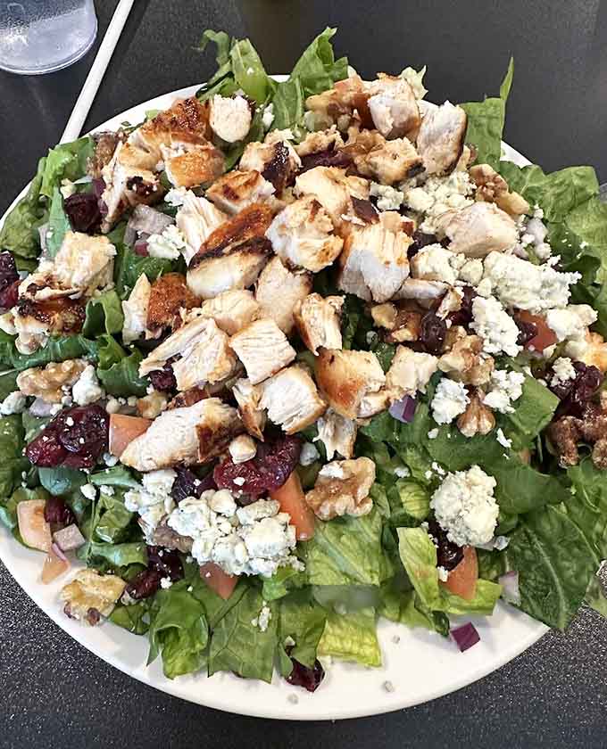 Savor every bite of this fresh, hearty salad topped with grilled chicken, crunchy walnuts, and savory blue cheese crumbles.