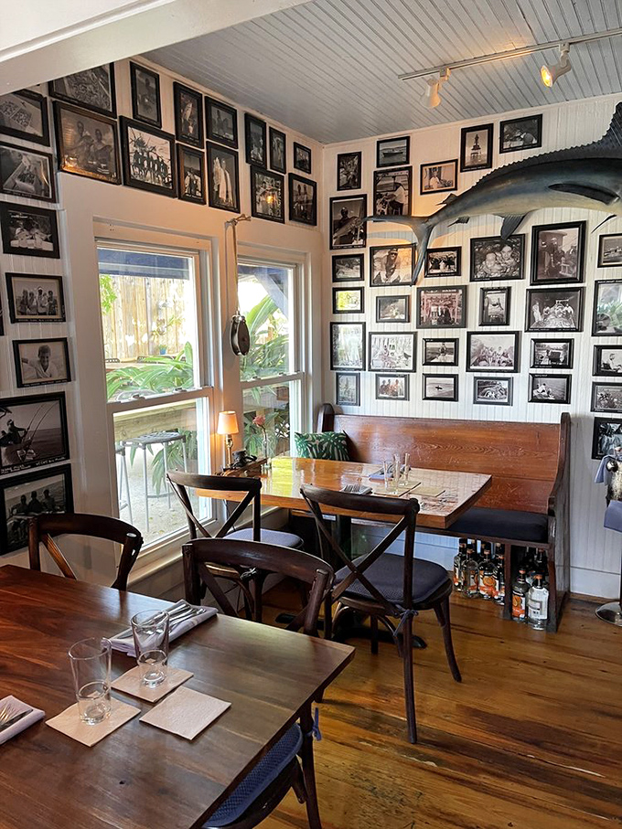 History lines the walls in black and white photographs, telling fishing tales while diners create new memories at wooden tables below.