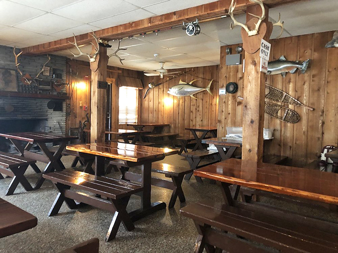 Wood-paneled walls, mounted fish, and picnic-style seating create an atmosphere of rustic charm that's increasingly rare in modern restaurants.