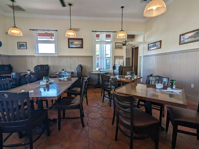 Warm wood tones and thoughtful spacing create a dining room where conversations flow as easily as the coffee.