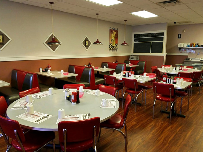 A dining room designed for comfort, where red booths invite you to settle in for a leisurely breakfast experience.