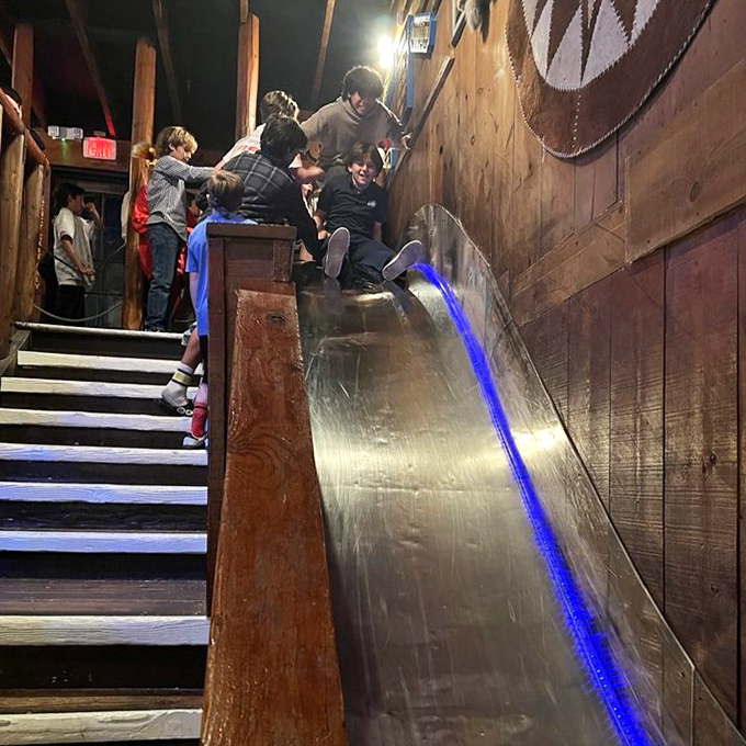 The infamous slide offers an alternative entrance to the dining room – because cowboys never take stairs when they can make a grand entrance.