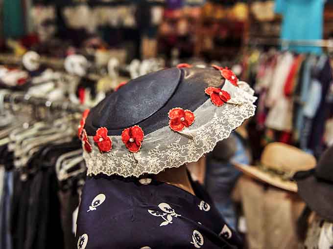 A dramatic black hat with delicate lace trim and bold red flowers would make any Kentucky Derby attendee green with envy.