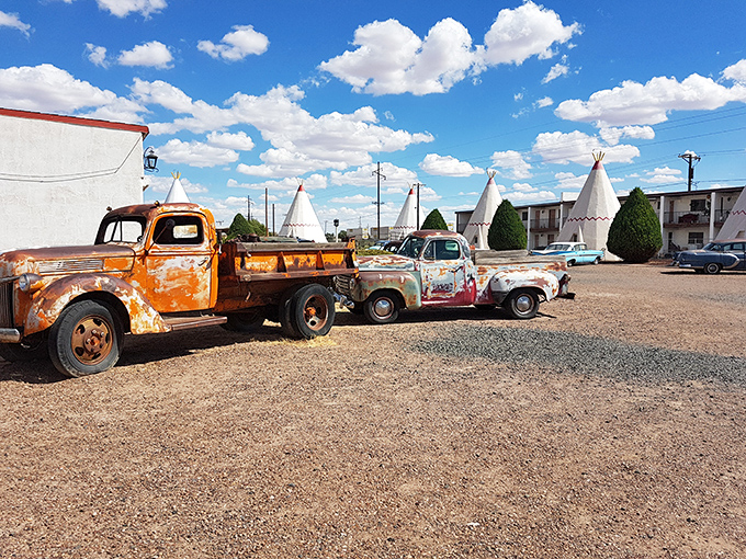 Rust-kissed vintage trucks stand guard like sentinels of a bygone era, when road trips were adventures and motels had personality.