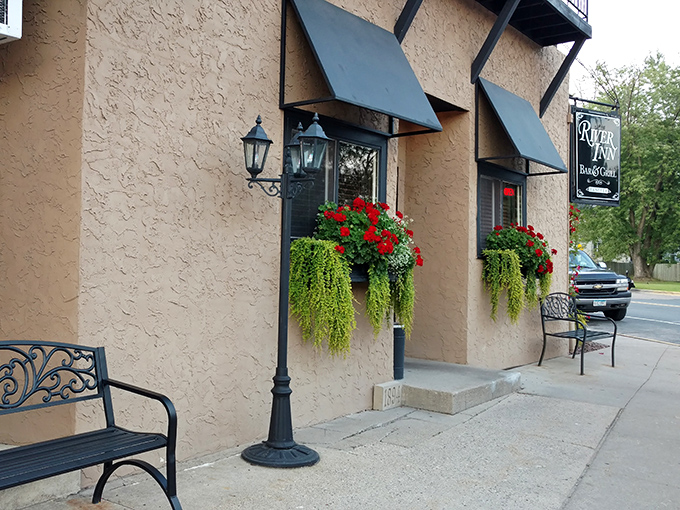 Flower boxes and vintage-style lamps frame the entrance, creating a welcoming first impression that promises homestyle comfort inside.
