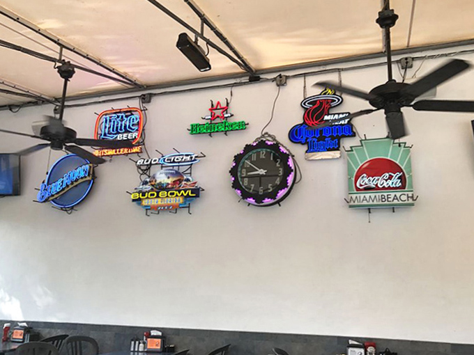 Neon signs illuminate the walls like electric art – each one a glowing testament to brands that fueled America's road trips and late nights.