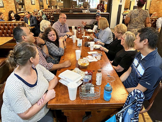 Community happens here &ndash; diverse groups of diners gather around Kewpee's tables, sharing not just meals but the authentic experience of Lansing's food culture.