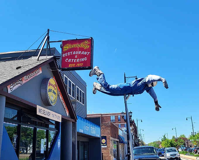 Starship Restaurant's eye-catching exterior features a suspended astronaut that appears to float above this uniquely shaped space-themed eatery.