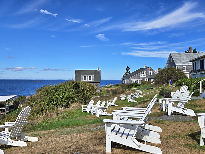 White Adirondack chairs face the endless horizon, nature's theater where no two performances are ever the same.