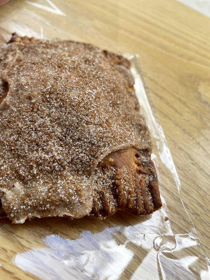 Cinnamon sugar sparkles atop this apple-filled pastry like morning sunshine &ndash; a sweet treat that pairs perfectly with their robust coffee.