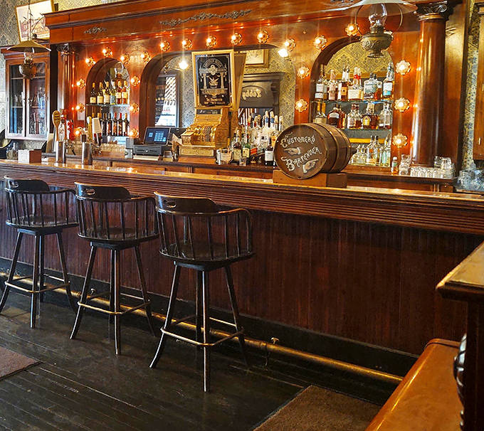The saloon-style bar gleams with polished wood and vintage charm, offering liquid courage before you face down a Cowboy Steak.