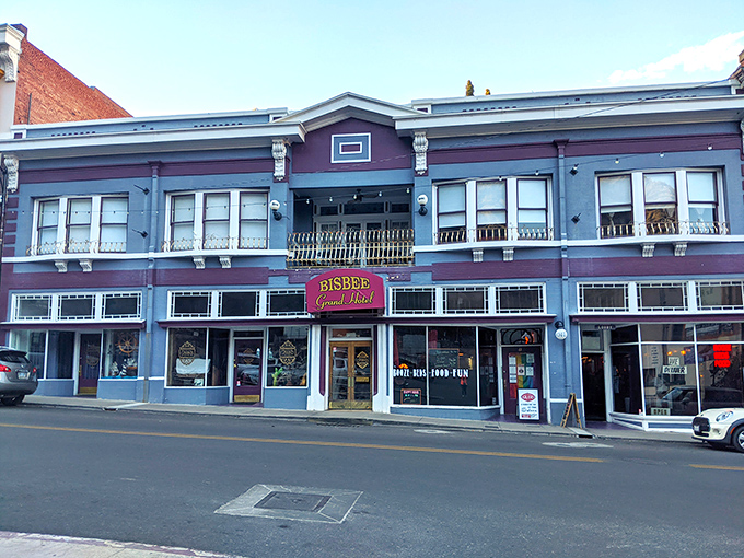 The historic Bisbee Grand Hotel stands as a Victorian beauty queen on Main Street, her blue facade hiding rooms where miners, madams, and millionaires once slept.
