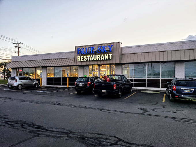 The parking area at dusk &ndash; where cars gather like faithful worshippers at the temple of good eating.