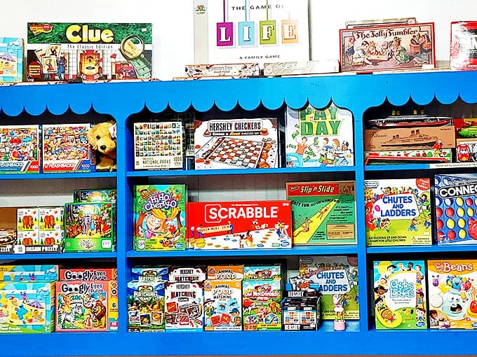Classic board games line the shelves, offering screen-free entertainment that pairs perfectly with a bag of freshly selected sweets.