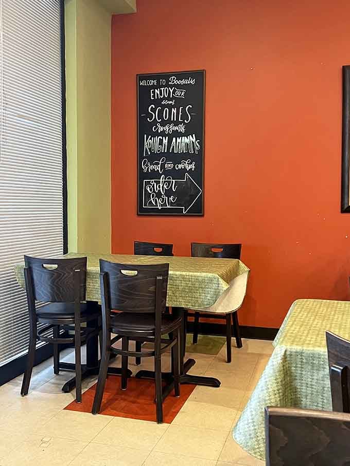 Cozy dining area with cheerful walls inviting you to sit, relax, and enjoy your pastries without rushing back to reality.