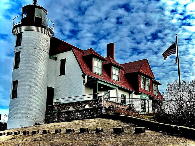 Point Betsie Lighthouse stands guard where land meets lake, its red-roofed charm straight from a maritime storybook that never gets old.