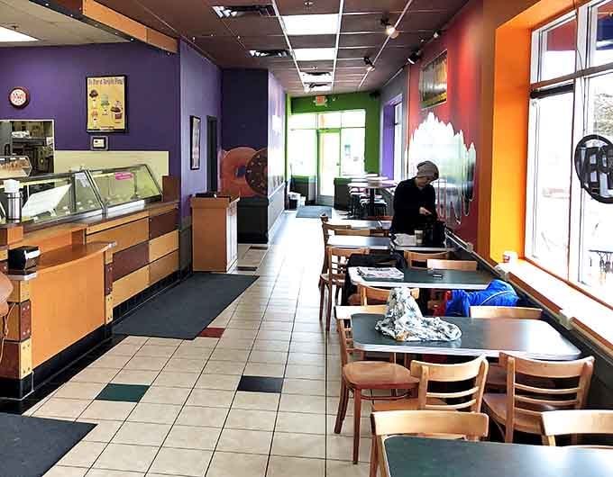 The dining area offers a comfortable spot to savor your selections, with colorful walls that match the vibrant treats.