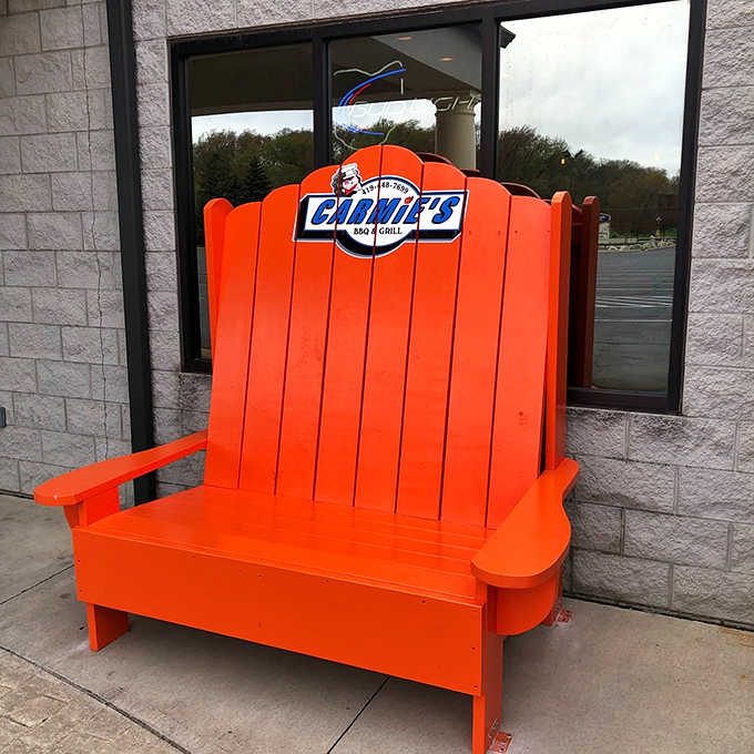 That iconic orange Adirondack chair – Carmie's unofficial mascot and the most photographed seat in Tiffin, Ohio.
