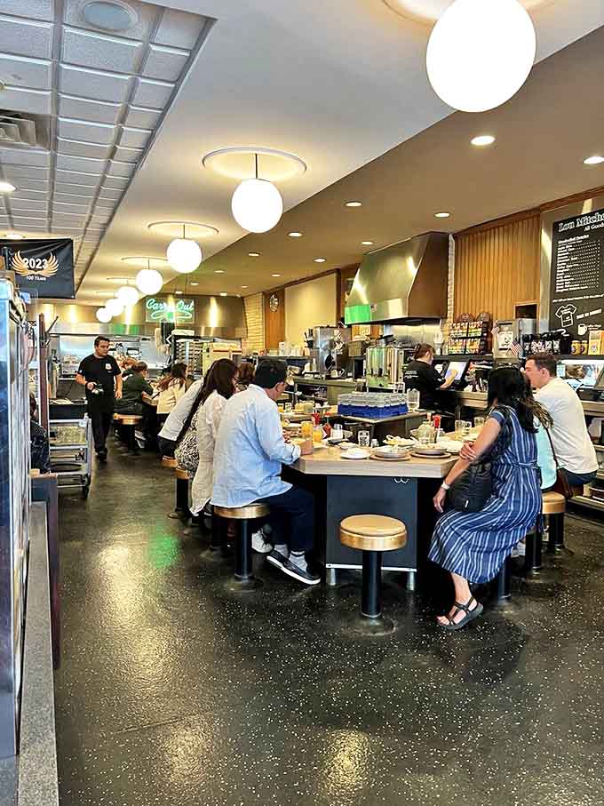 The lively atmosphere brings together solo diners, couples, and families, all united in their appreciation for exceptional morning meals.