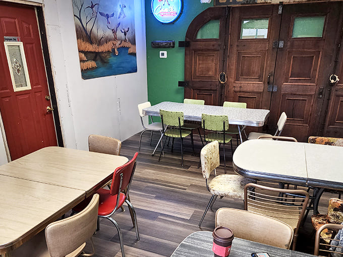 The dining area's mismatched tables and chairs aren't a design statement &ndash; they're an invitation to sit, stay, and become part of the MacDaddy's community.