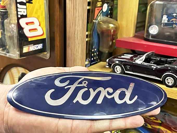 That Ford emblem in someone's hand represents decades of American automotive pride, small enough to hold but mighty in nostalgia.