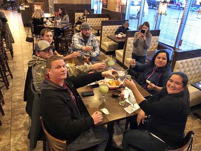 Happy diners sharing plates and stories, proof that great food creates the best kind of gathering every time.