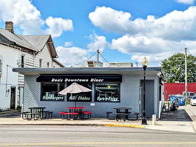 When Ohio weather cooperates, these red tables become prime real estate for enjoying diner classics under blue skies. Simple pleasures at their finest.
