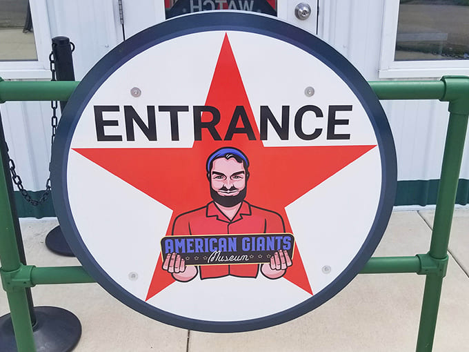 The entrance sign welcomes visitors with a friendly face, promising giants but delivering something even better – pure American nostalgia.