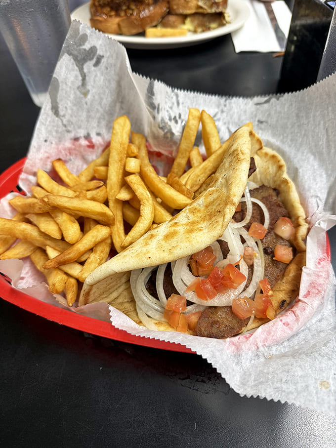 The gyro plate combines Mediterranean flavors with American abundance &ndash; seasoned meat, fresh vegetables, and golden fries create perfect harmony.