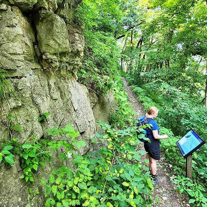 A hiker pauses to read nature's fine print &ndash; those informational signs are like spoiler alerts for the geological plot twists ahead.