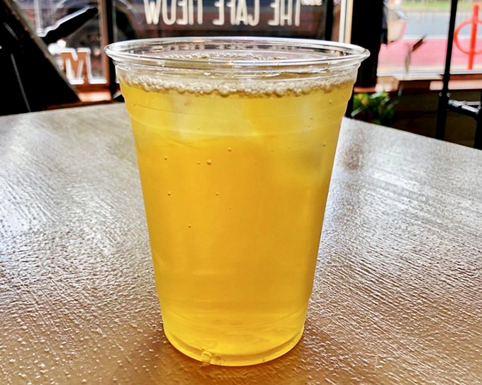 The ginger peach iced tea glows amber in the afternoon light &ndash; a refreshing reward after an intense play session.