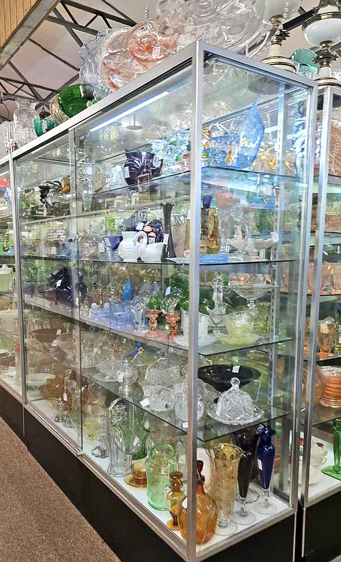 Glassware Display: Crystal and colored glass catch the light like frozen rainbows, each delicate piece surviving decades of history to reach this showcase.
