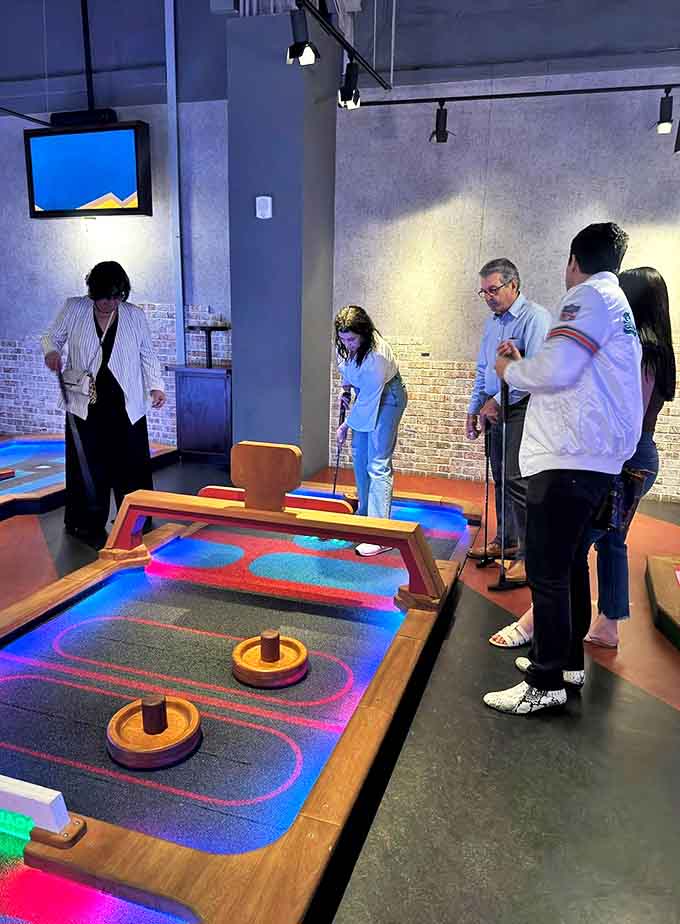 Multi-generational fun unfolds as this diverse group discovers that age and experience level mean nothing when faced with Puttshack's creative challenges.