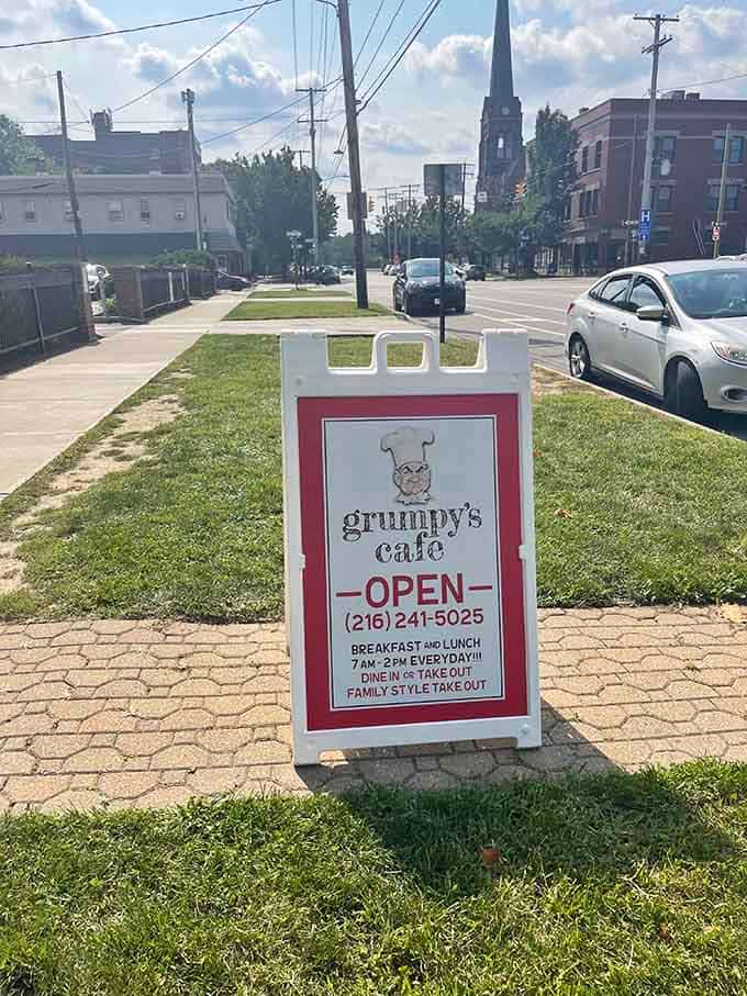 A friendly sidewalk sign welcomes hungry passersby with hours and a promise of family-style comfort food worth getting out of bed for.