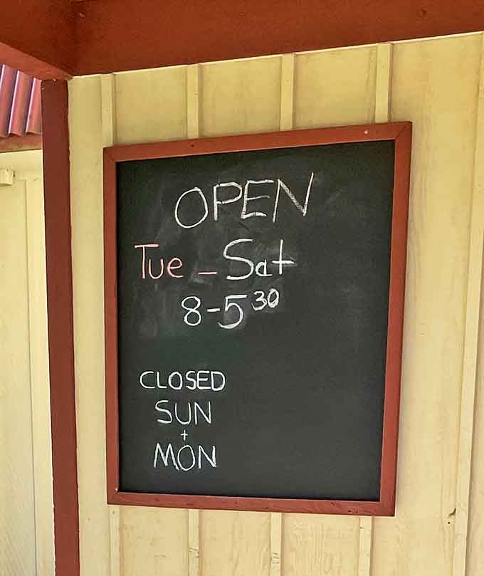 The hours chalkboard – where "Closed Sunday & Monday" translates to "Plan your donut cravings accordingly or face crushing disappointment."