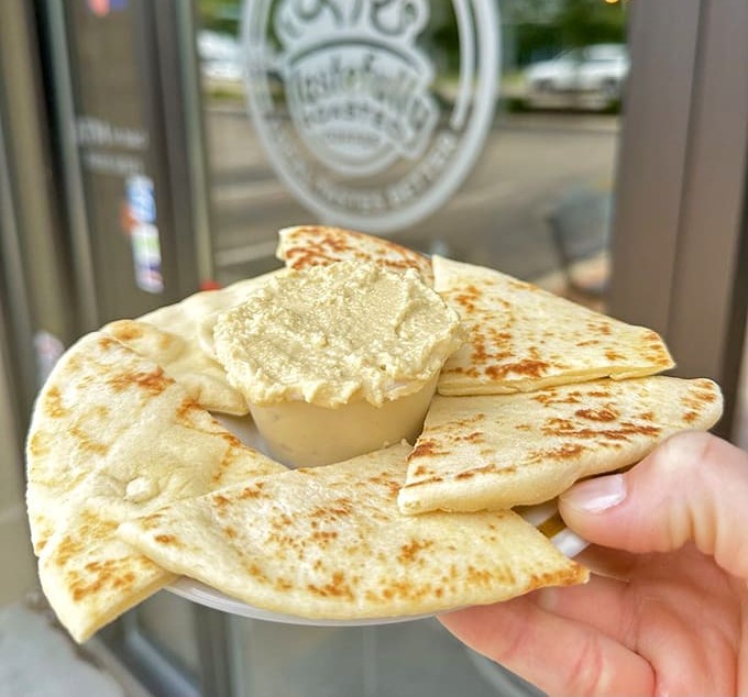 Hummus and warm naan create a simple yet satisfying plate &ndash; proof that Tastefully Roasted excels beyond its coffee and pastry fame.