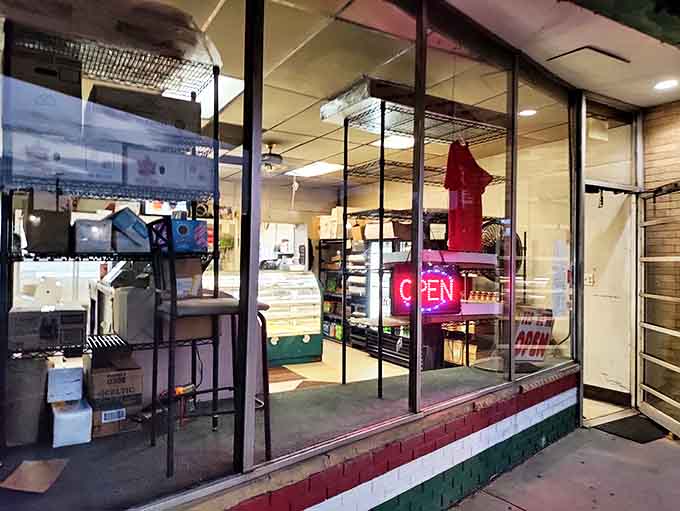 The storefront beckons with its simple promise of authentic Italian baked goods. That "OPEN" sign is the best news you'll get all day.