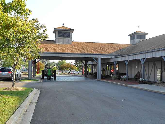 The covered entrance provides shelter from Midwestern weather extremes while vintage farm equipment hints at the agricultural theme within.