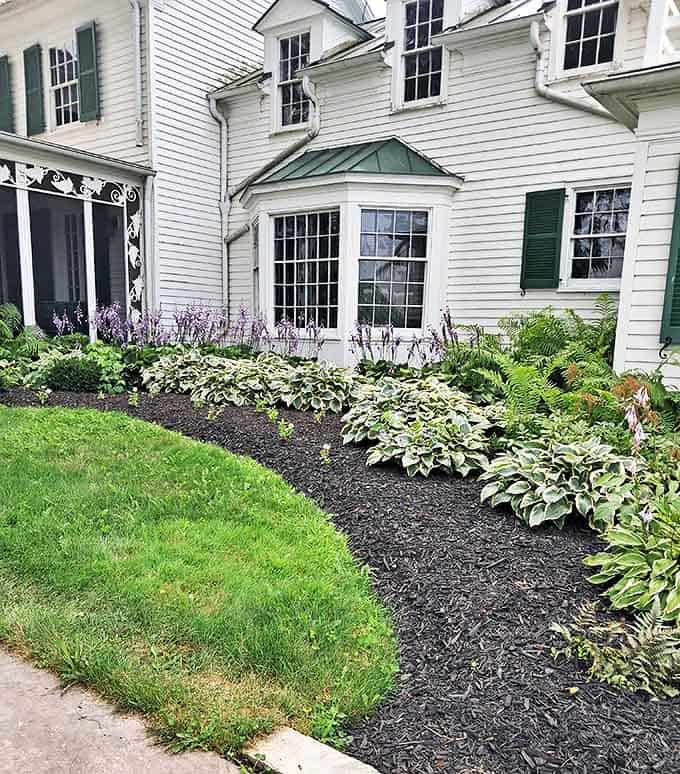 Thoughtfully designed gardens surround the main house, blending ornamental beauty with practical plantings.