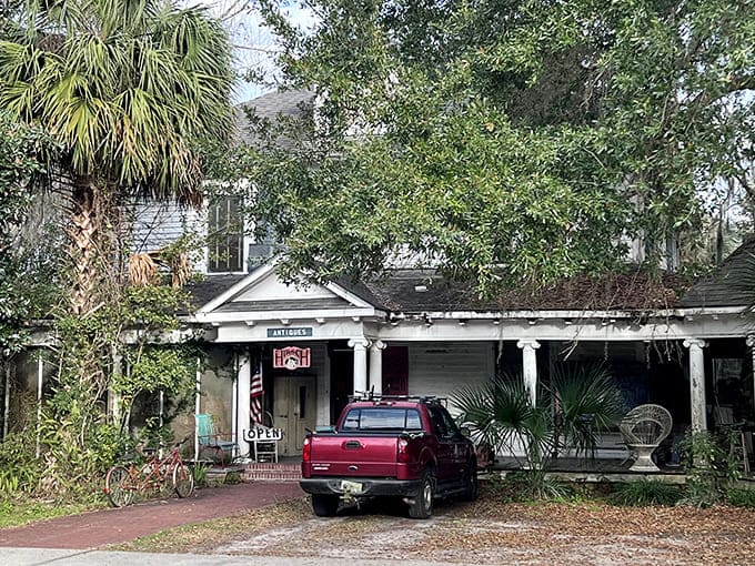 This weathered porch has welcomed generations of visitors, its worn steps telling stories of countless comings and goings through Micanopy's quiet history.